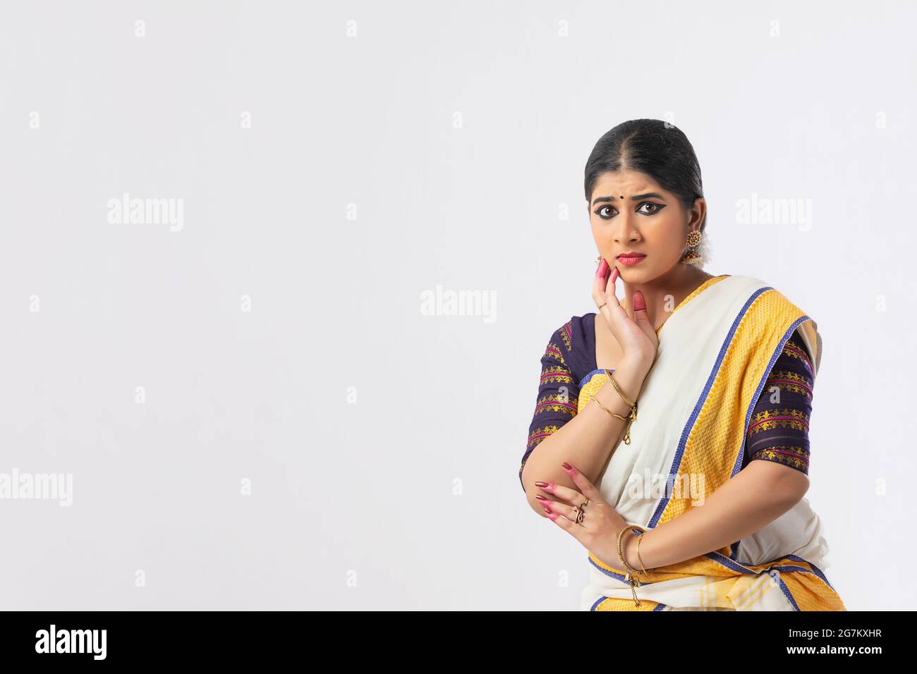 Mohiniattam dancer in Hamsapaksha mudra looking with worried ...