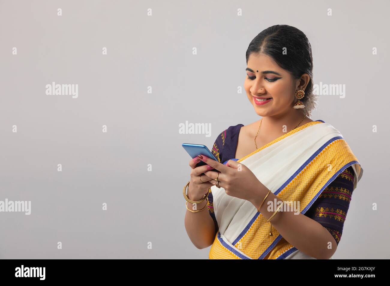 Indian classical dancer smiling while texting on her phone Stock Photo ...