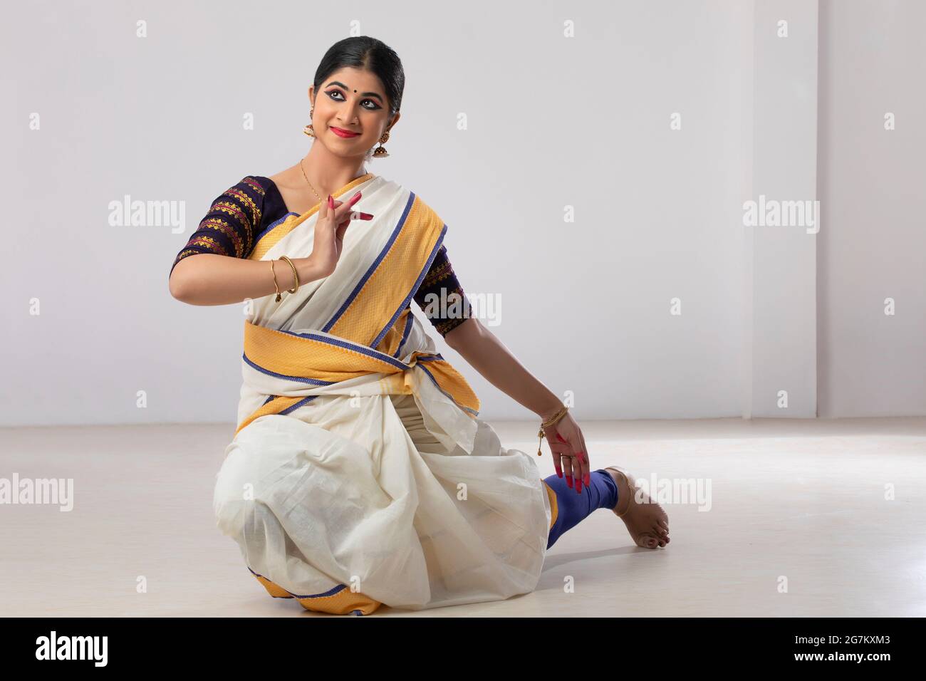 Mohiniattam dancer depicting a gopi dancing near Lord Krishna Stock ...