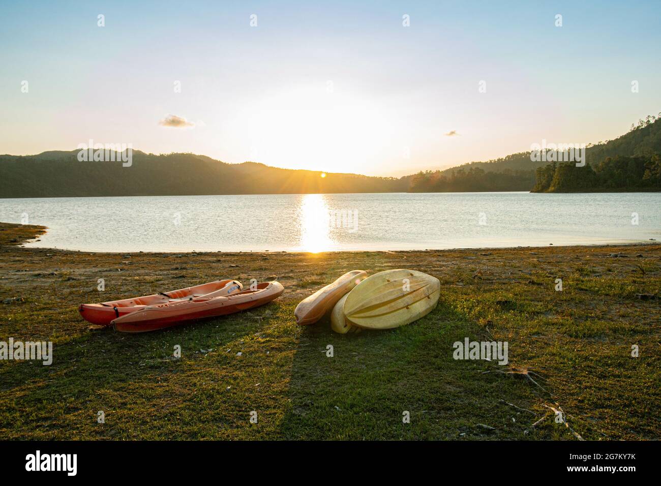 Mesmerizing view of several boats during scenic sunrise in the lake ...