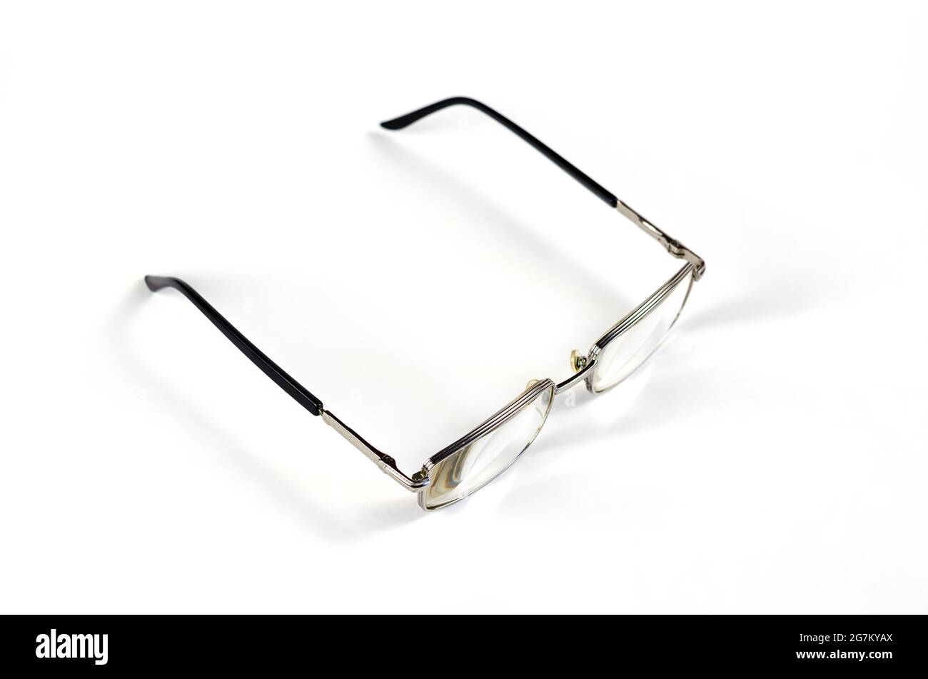 Reading glasses on a white background. Metal-rimmed glasses with ...