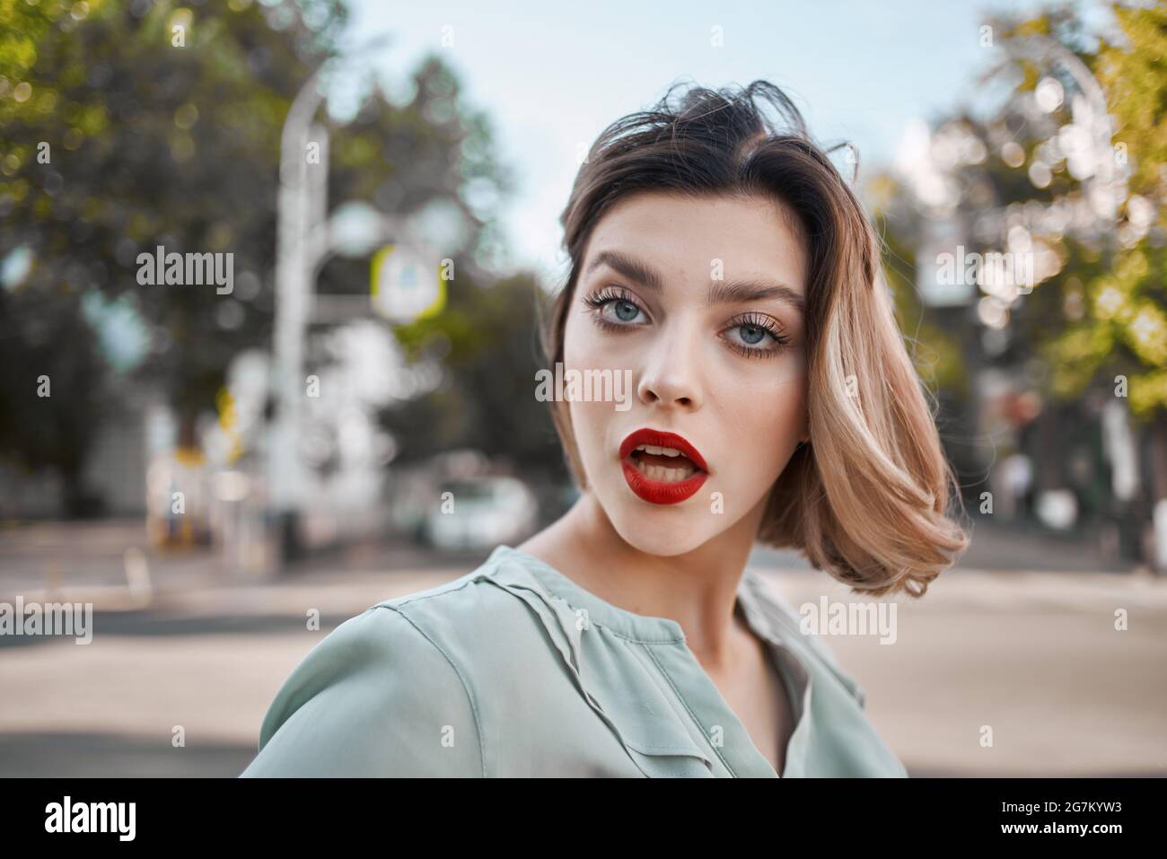 pretty woman outdoors red lips walk outdoors lifestyle Stock Photo - Alamy