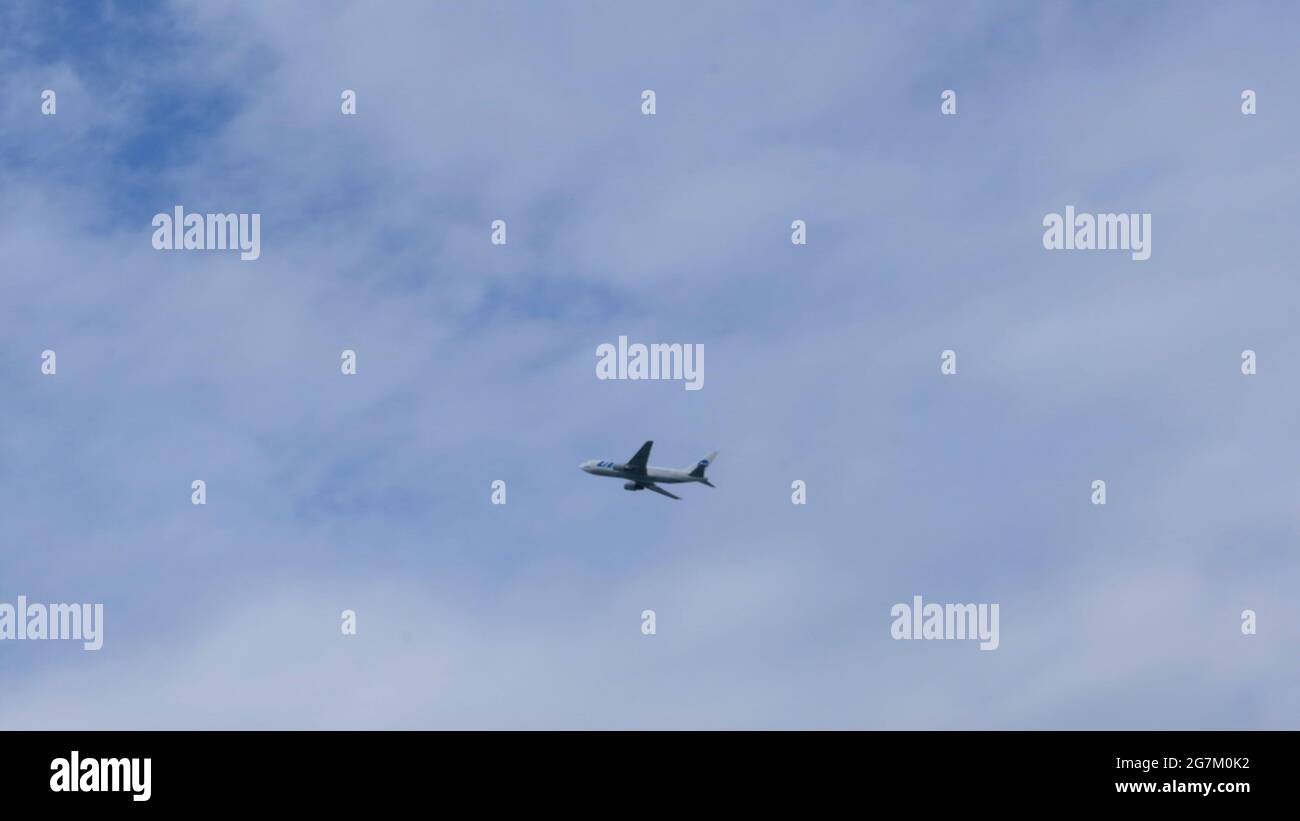 Modern large plane flies in the sky. Beautiful blue sky and white ...