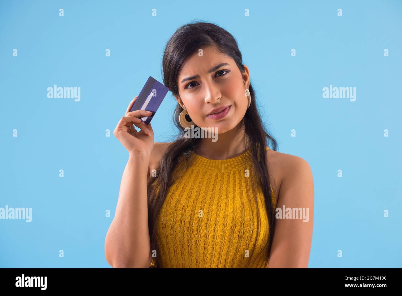 A young woman thinking something with credit card in her hand Stock ...