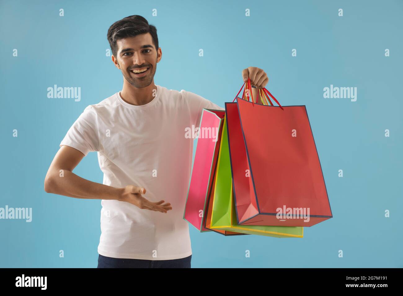A young man pointing towards his Carry bags Stock Photo - Alamy