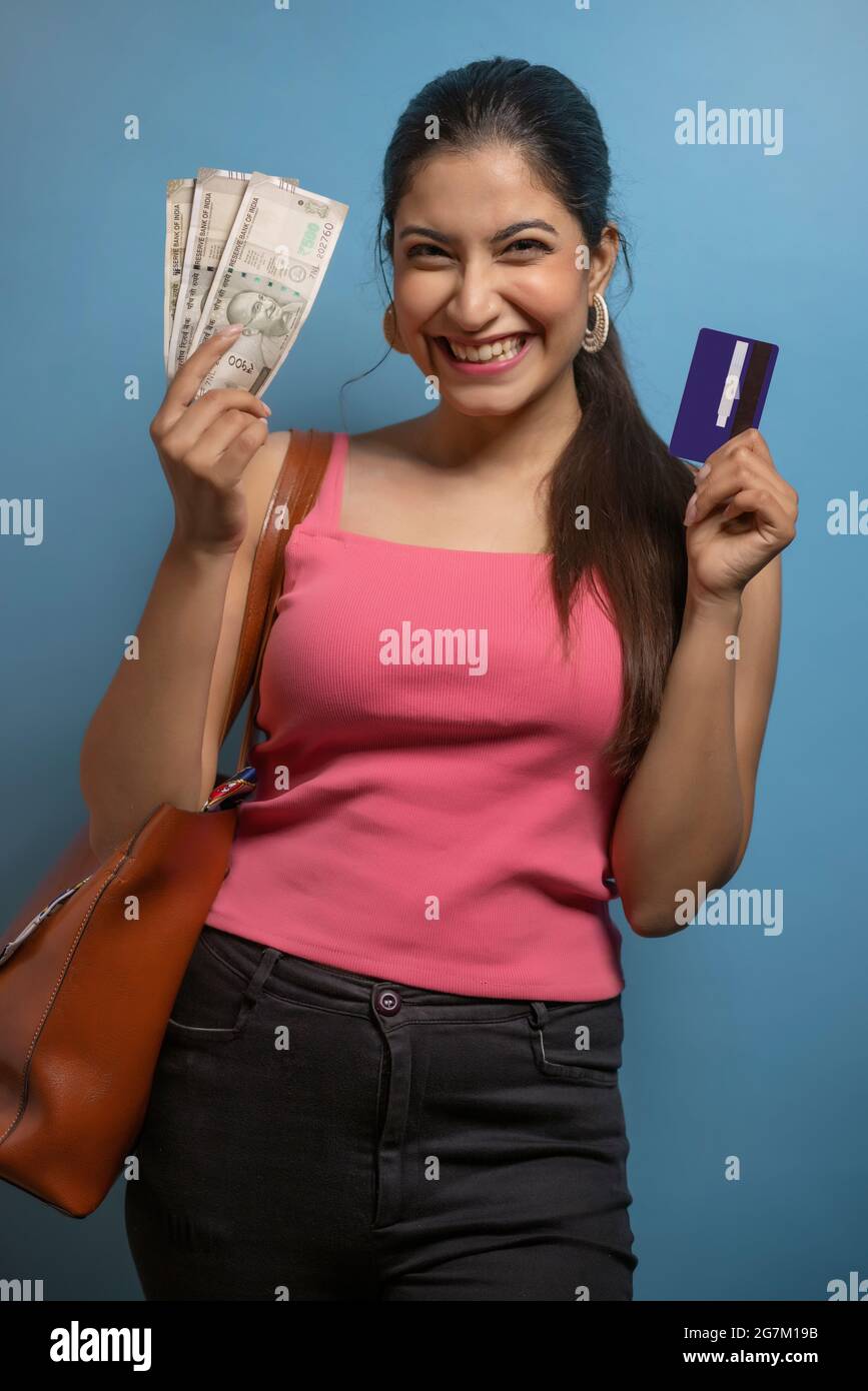 A girl with a handbag showing her cash and card Stock Photo - Alamy