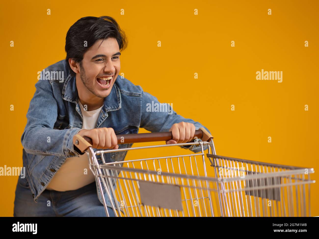 A young boy happily moving a trolley Stock Photo - Alamy