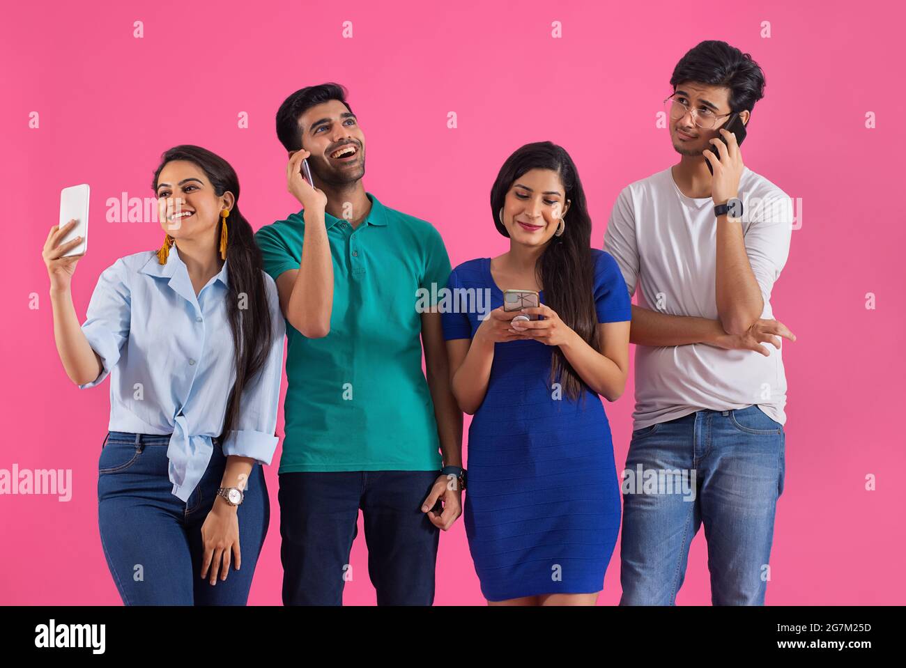 A group of friends engaged with their phone in different ways Stock ...