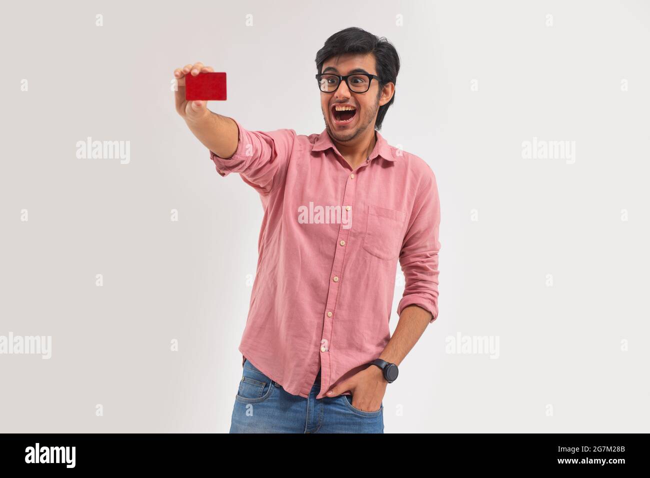 A young man excitedly looking at his credit card Stock Photo - Alamy