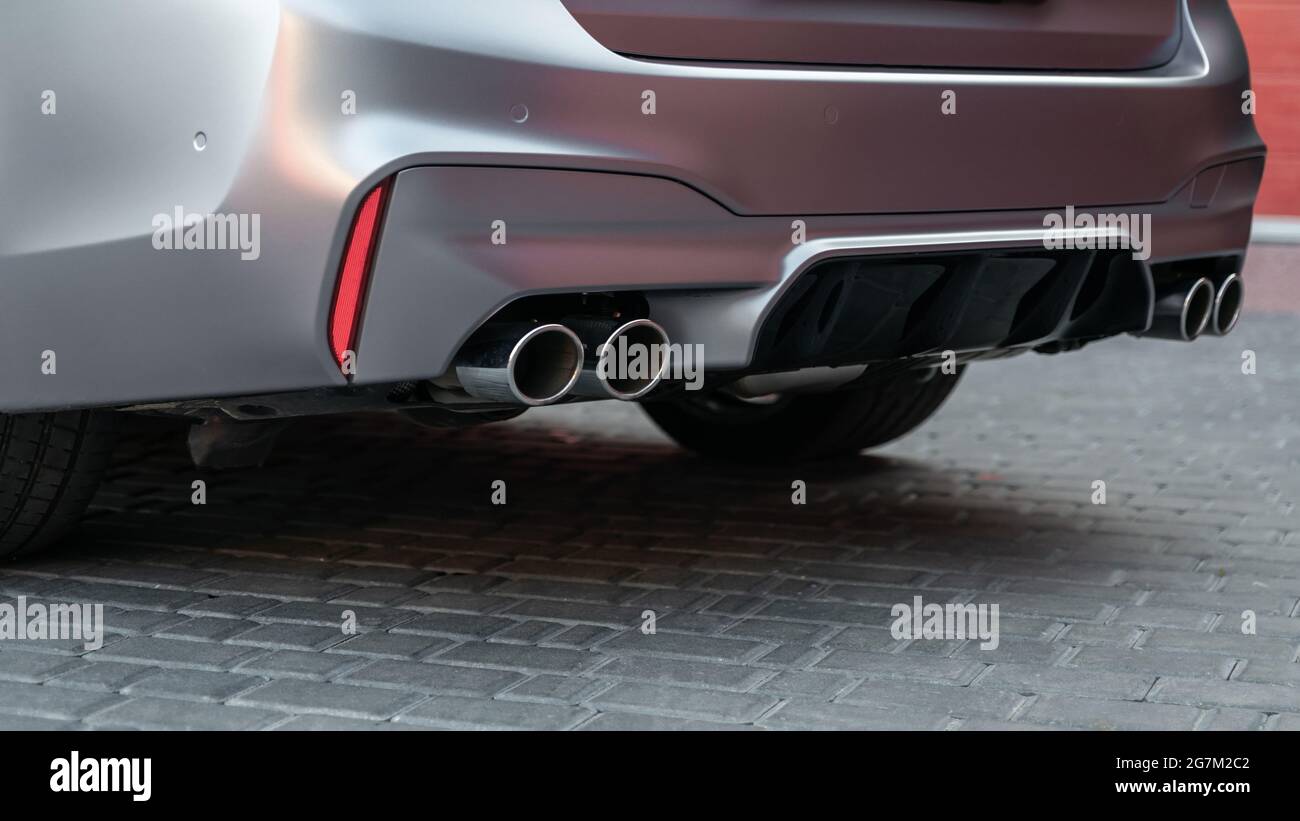 Modern car interior. Close up of new sport car with dual exhaust pipe ...