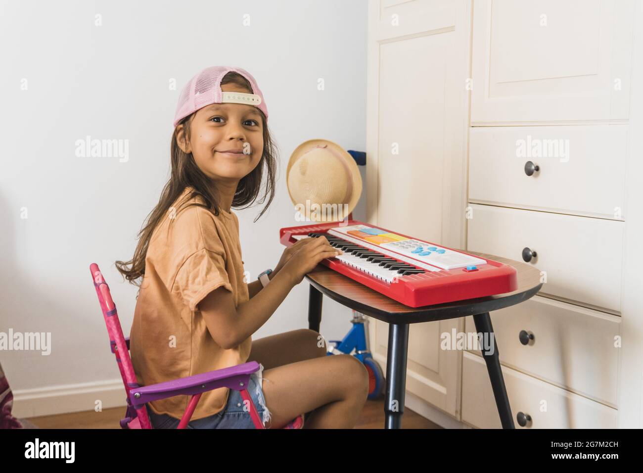 Young Hispanic girl playing piano Stock Photo - Alamy