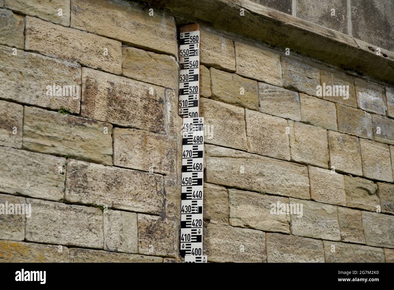 Water level meter on a stone wall Stock Photo - Alamy