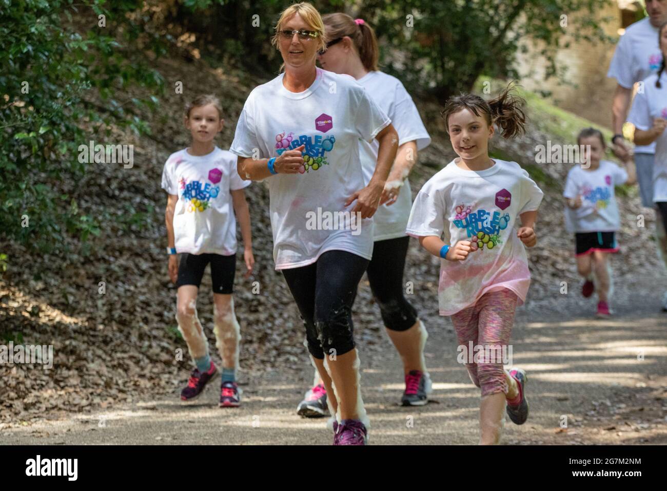 Bubble Rush players running between foam tanks Stock Photo - Alamy