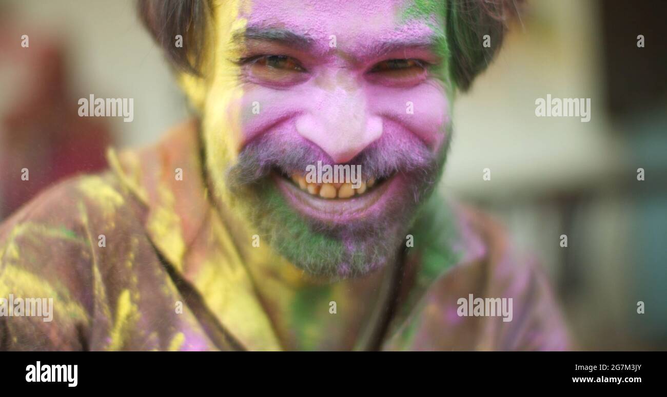 Portrait of a young happy smiling Indian male with a colored face ...