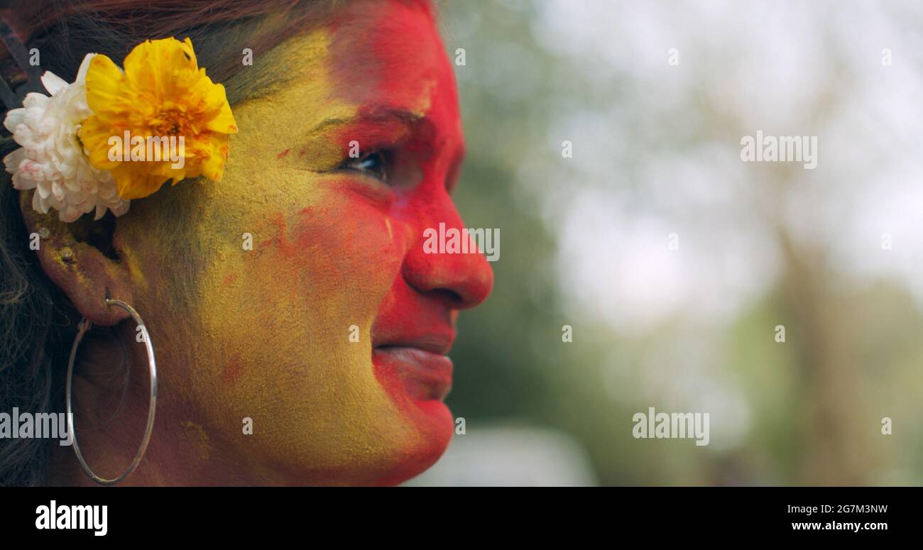 Profile portrait of a pretty Indian girl with a colored face during the ...