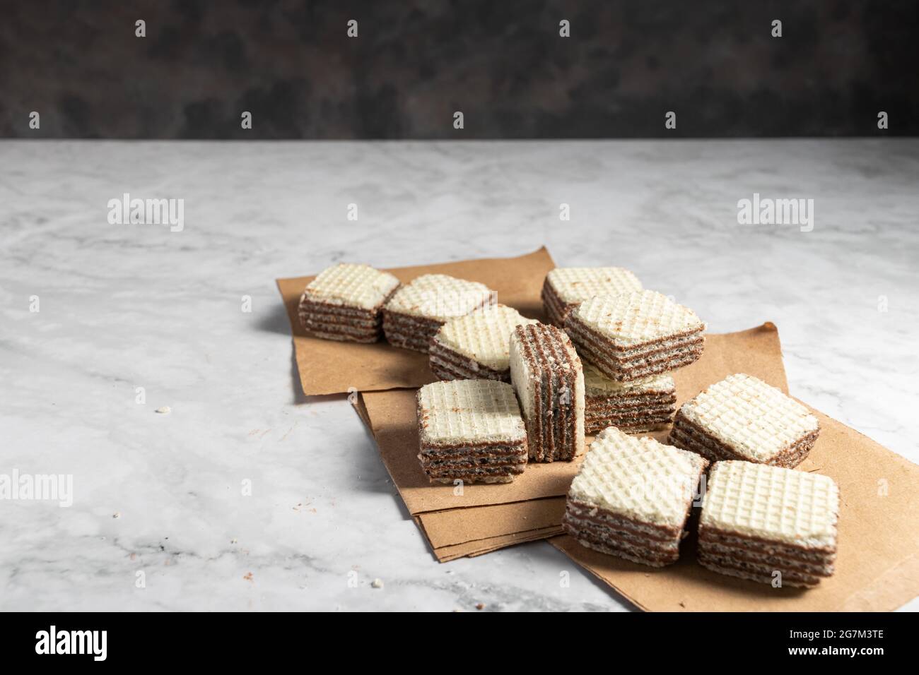 Closeup of square wafer biscuits with chocolate cream Stock Photo - Alamy