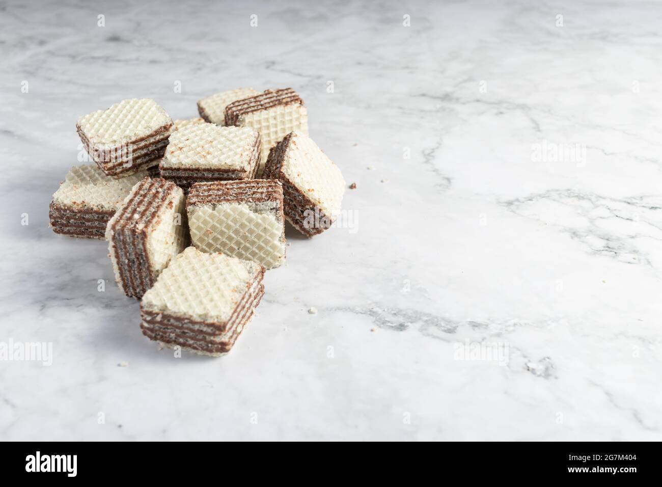 Closeup of square wafer biscuits with chocolate cream Stock Photo - Alamy