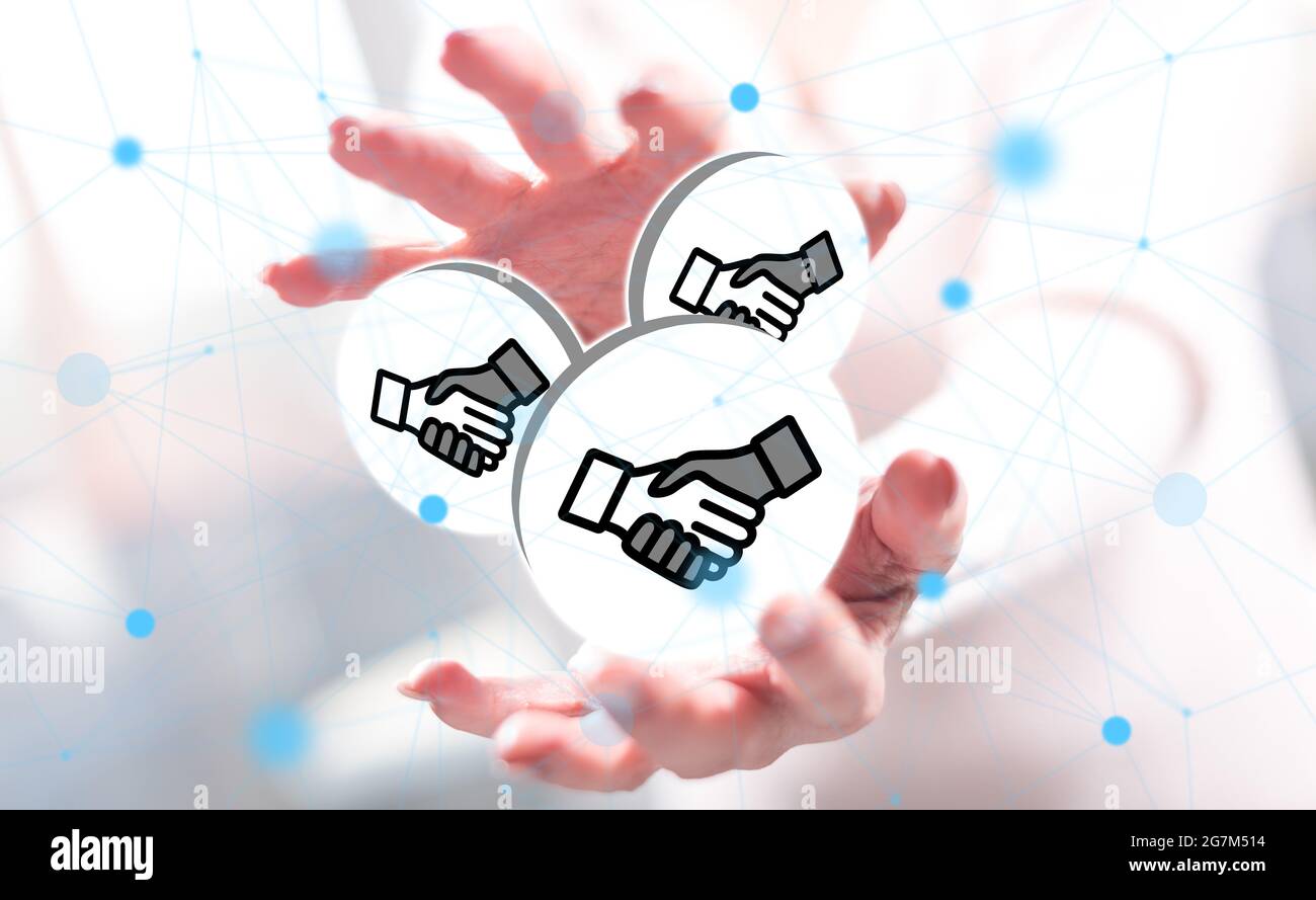 Partnership concept between hands of a woman in background Stock Photo ...