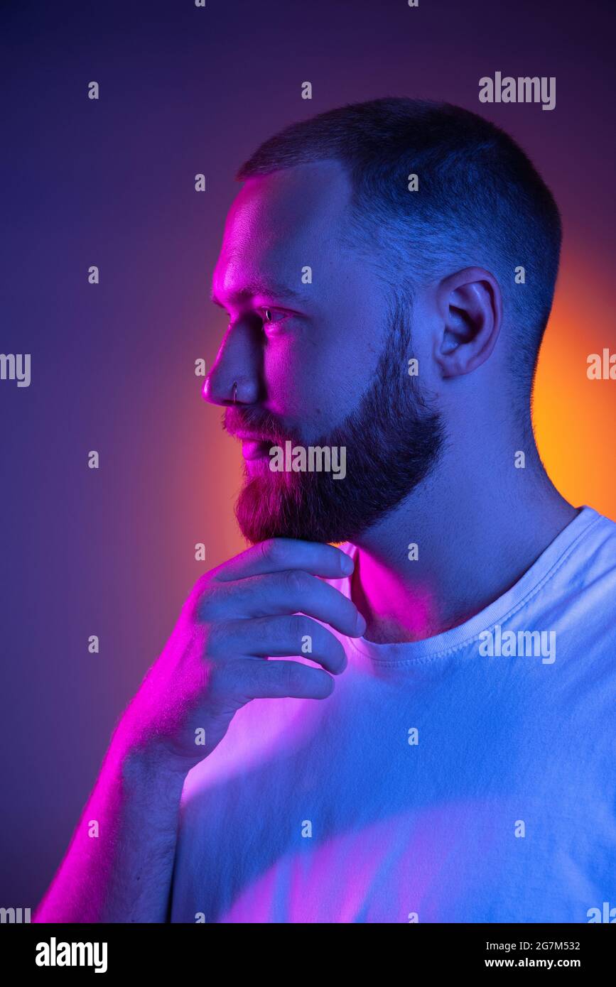Close up portrait of young caucasian bearded man isolated on dark ...