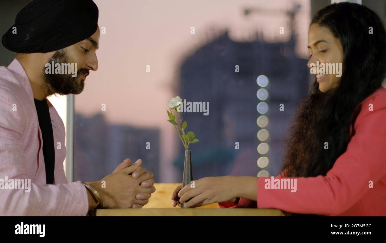 Cute Indian couple on a first date in a restaurant Stock Photo - Alamy