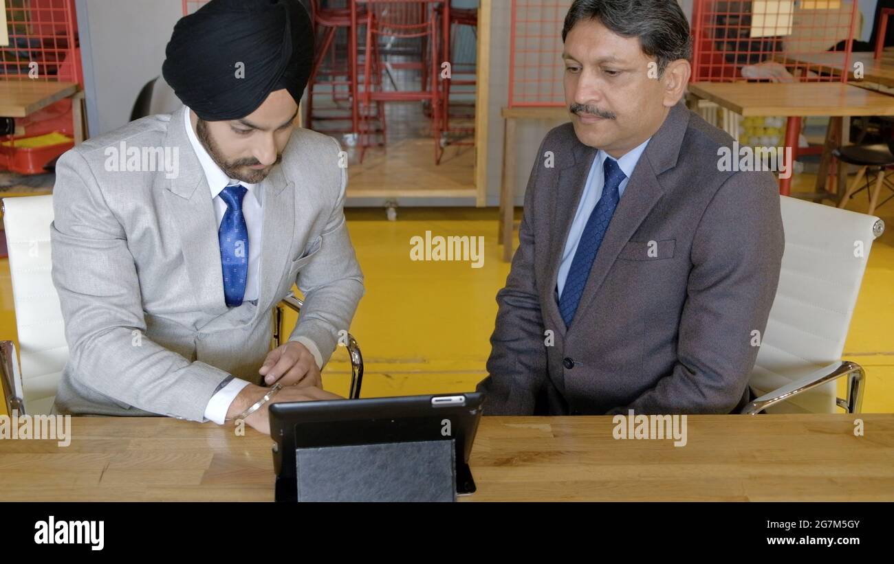 Indian male colleagues having a discussion at office Stock Photo - Alamy