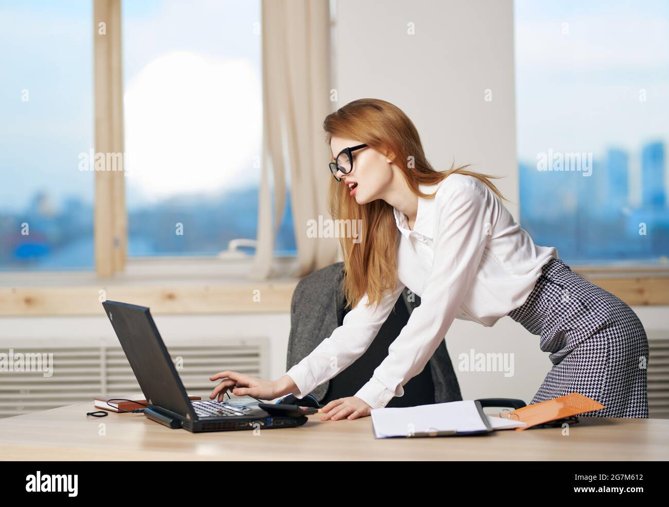 Woman secretary office desk laptop technology Stock Photo - Alamy