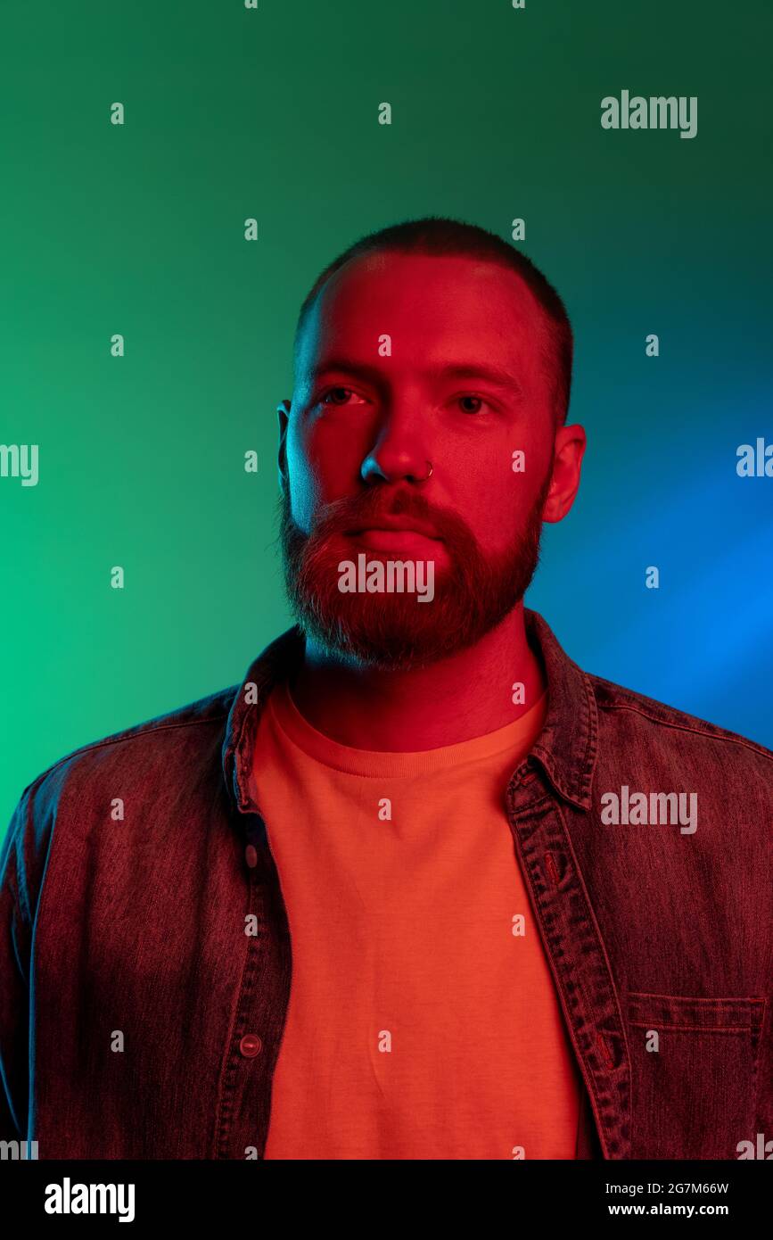 Calm, serious handsome caucasian man isolated on gradient green blue ...