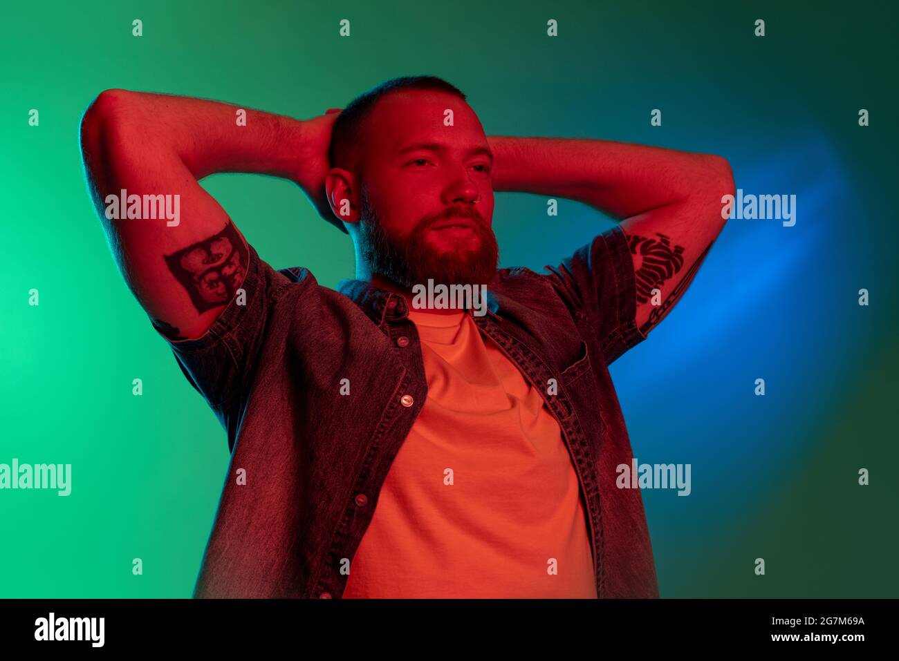 Portrait of young caucasian bearded man isolated on gradient blue green ...