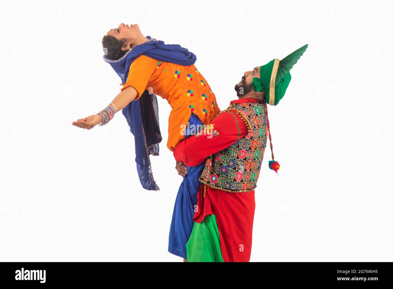 A Bhangra Dancer lifting a Giddha dancer depicting a dance step Stock ...