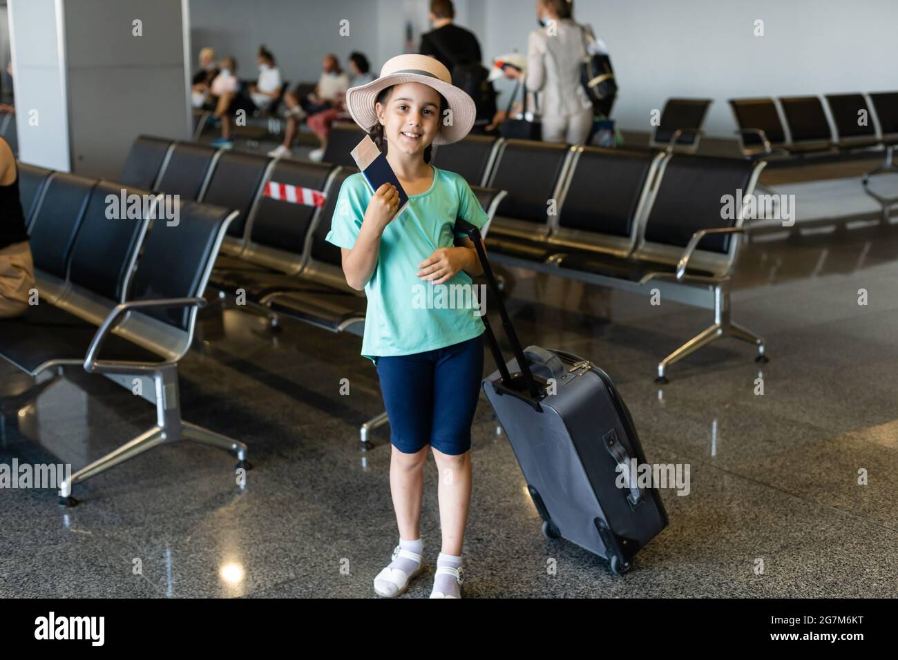 beautiful little girl holding passport and boarding pass at airport ...