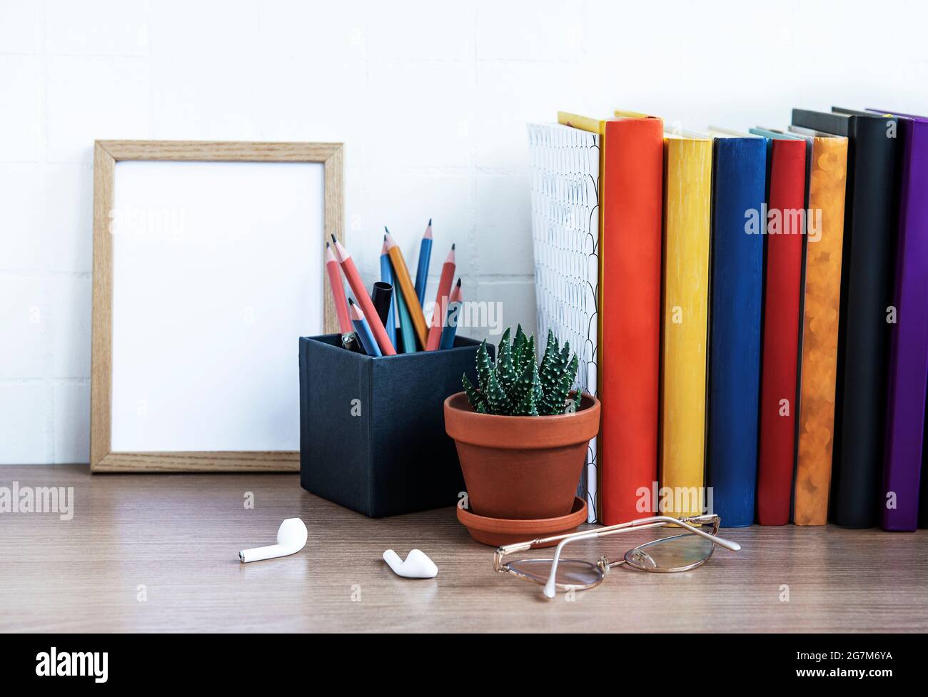 Stack of books on the desktop. Various books and office supplies on the ...