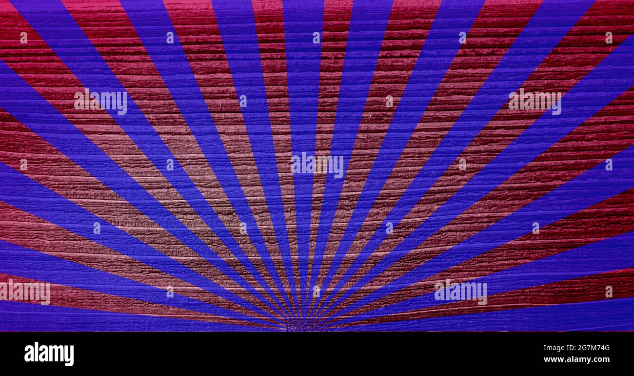 Digitally generated image of blue radial rays against textured wooden ...
