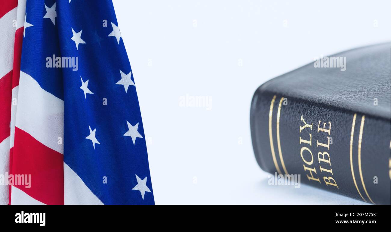 Digitally generated image of american flag and bible against white ...