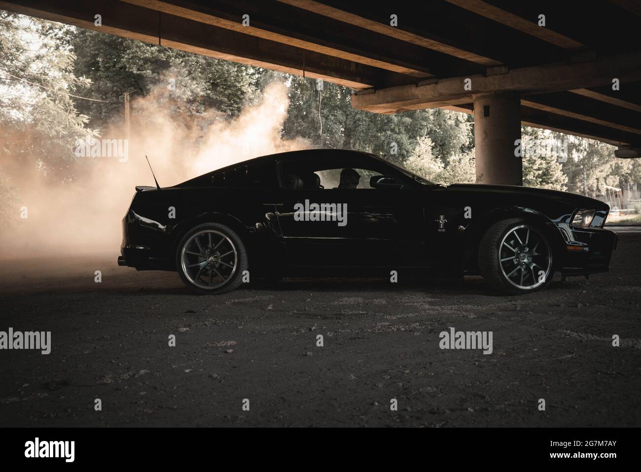 Black Ford Mustang drifting under the bridge Stock Photo - Alamy