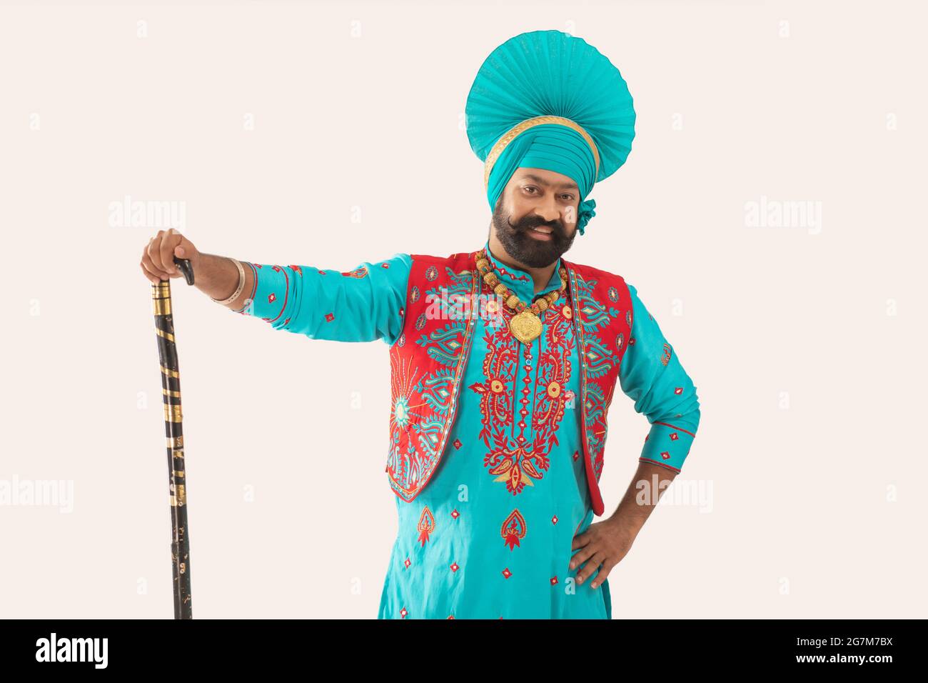 A Bhangra Dancer standing with a Khunda Stock Photo - Alamy
