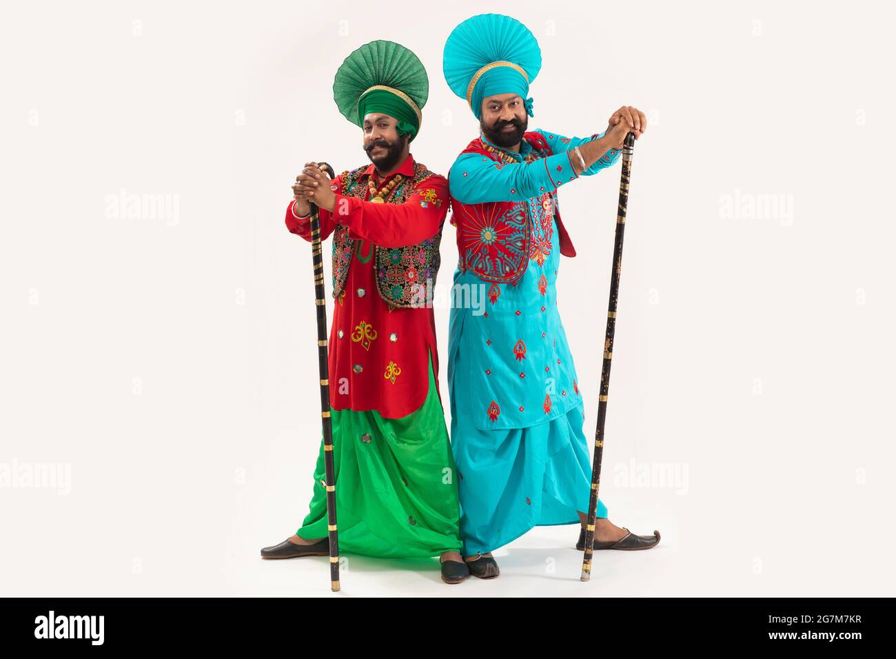Two Bhangra Dancers standing with Khunda Stock Photo - Alamy
