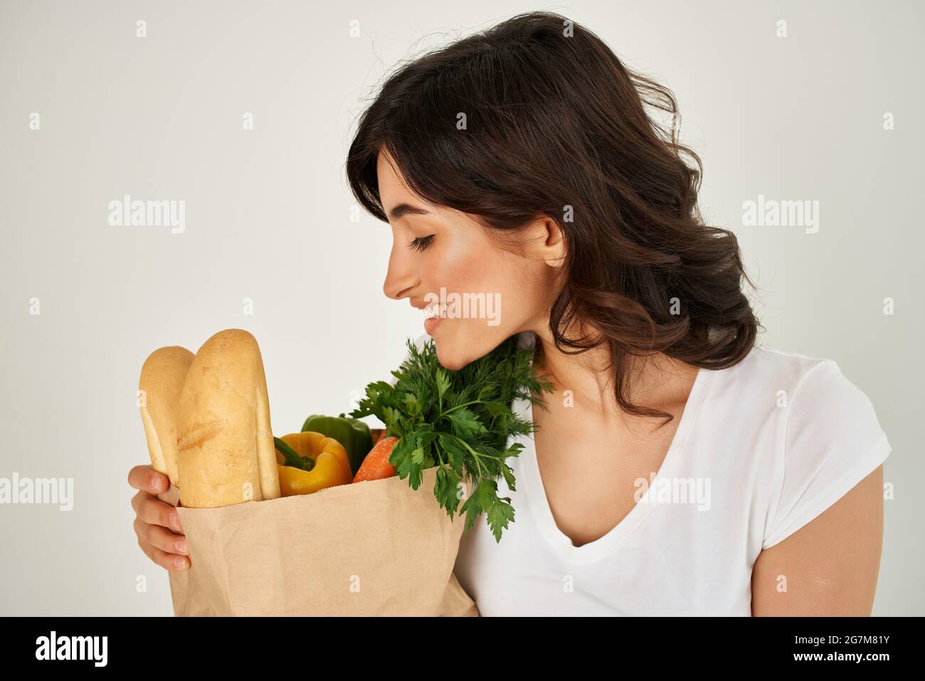 brunette in white t-shirt package with groceries healthy food delivery ...