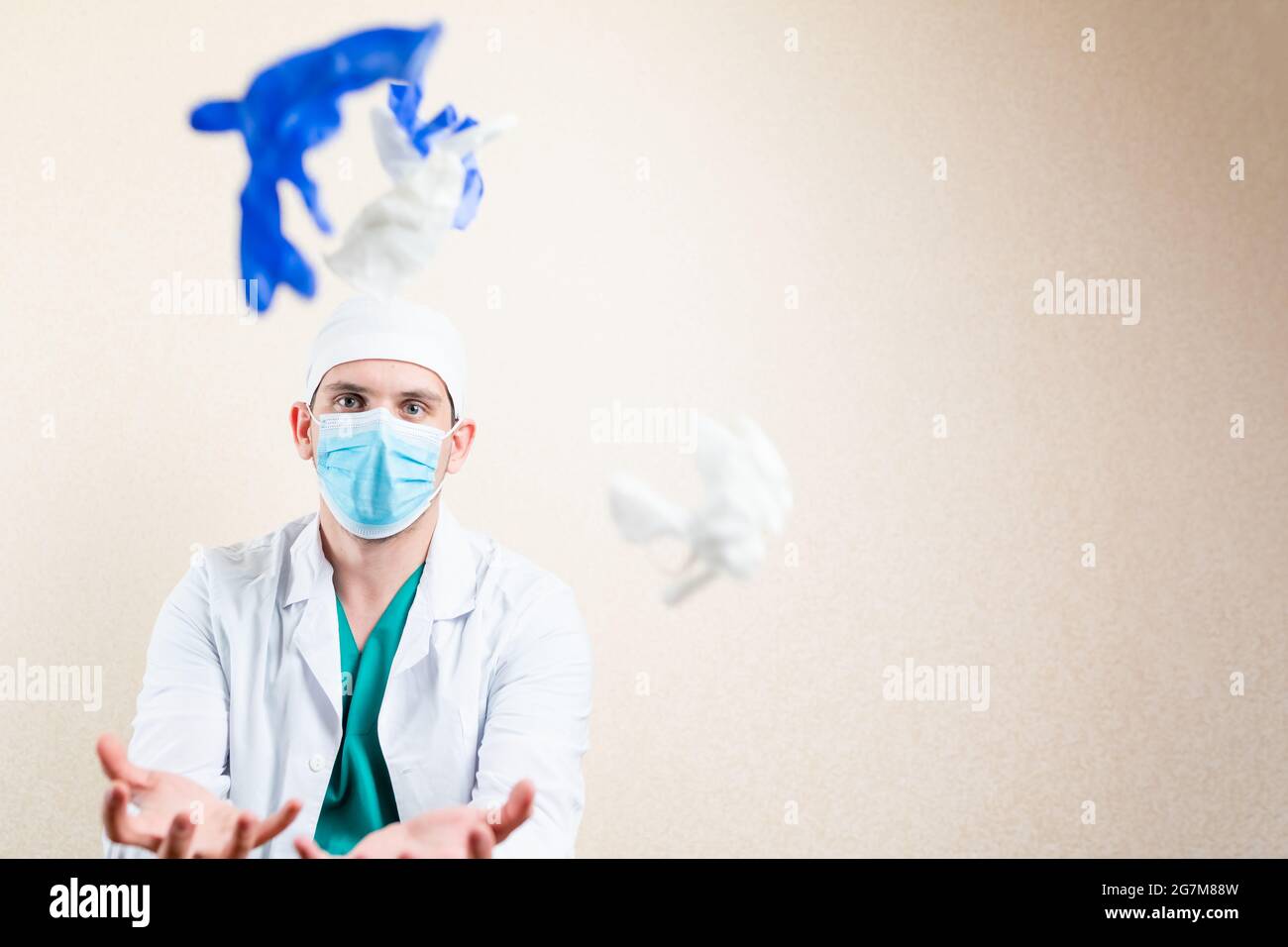 The doctor plays and throws up his gloves. On a light background Stock ...