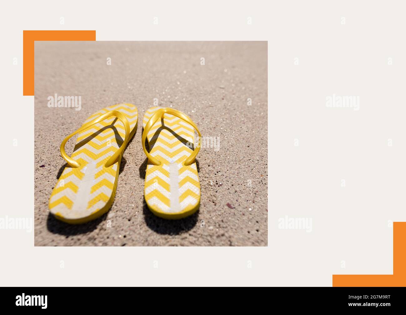 Photograph of yellow flip flops at the beach against grey background ...