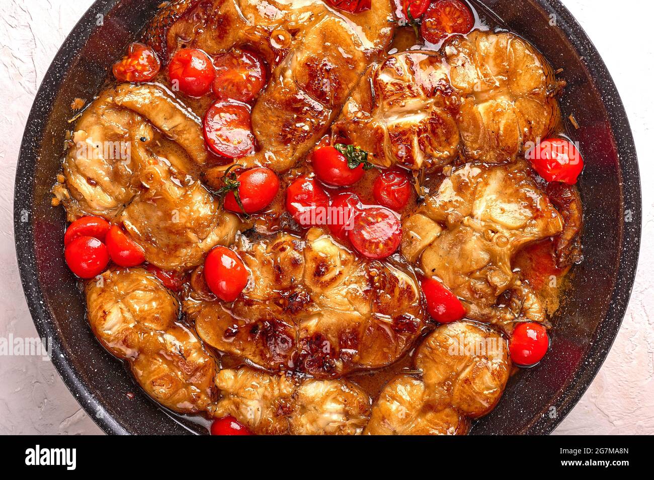 Traditional Sicilian fish with tomatoes and spices in in the pan. Food ...