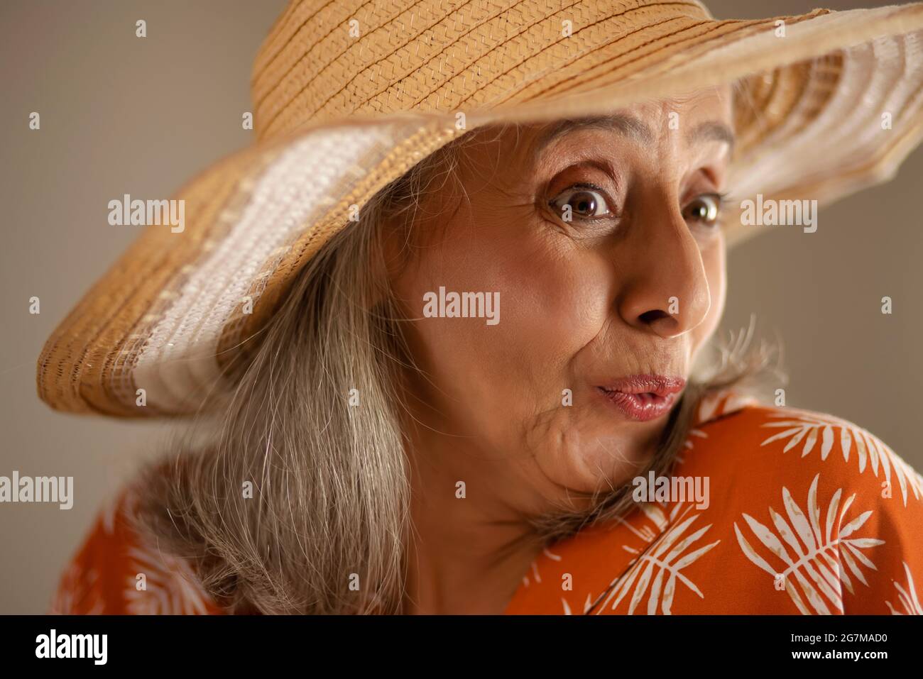 A Happy old woman expressing wonder wearing a hat Stock Photo - Alamy