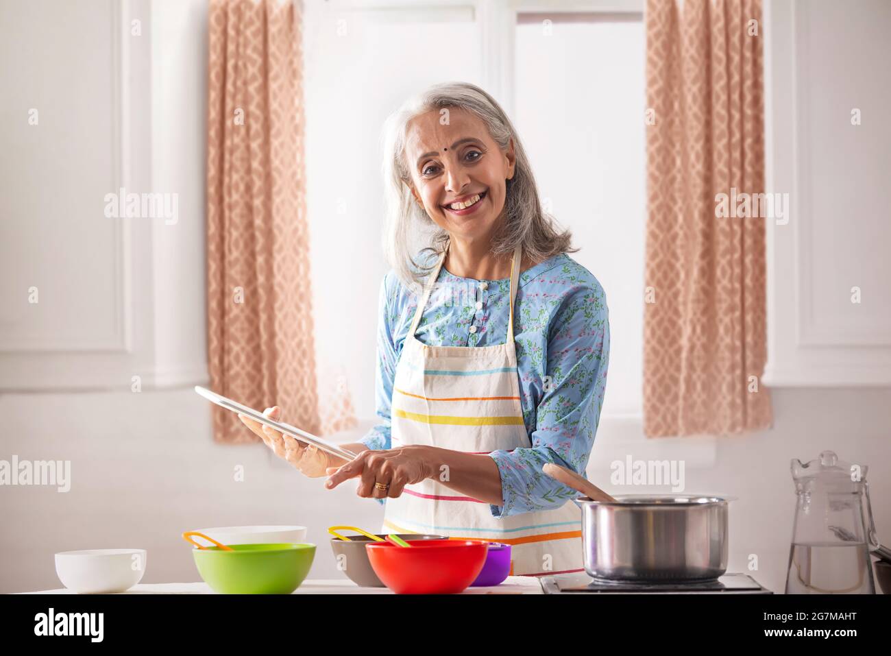 Indian senior lady cooking hi-res stock photography and images - Alamy
