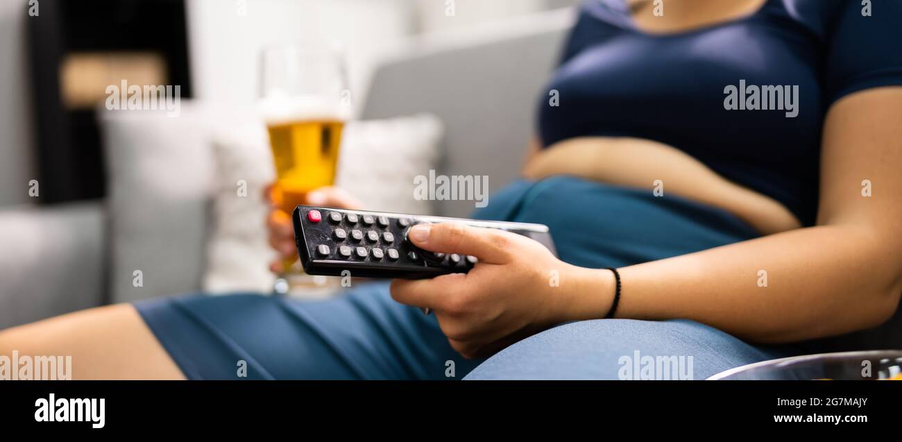 Overeating Junk Food, Drinking Beer And Watching TV Stock Photo - Alamy