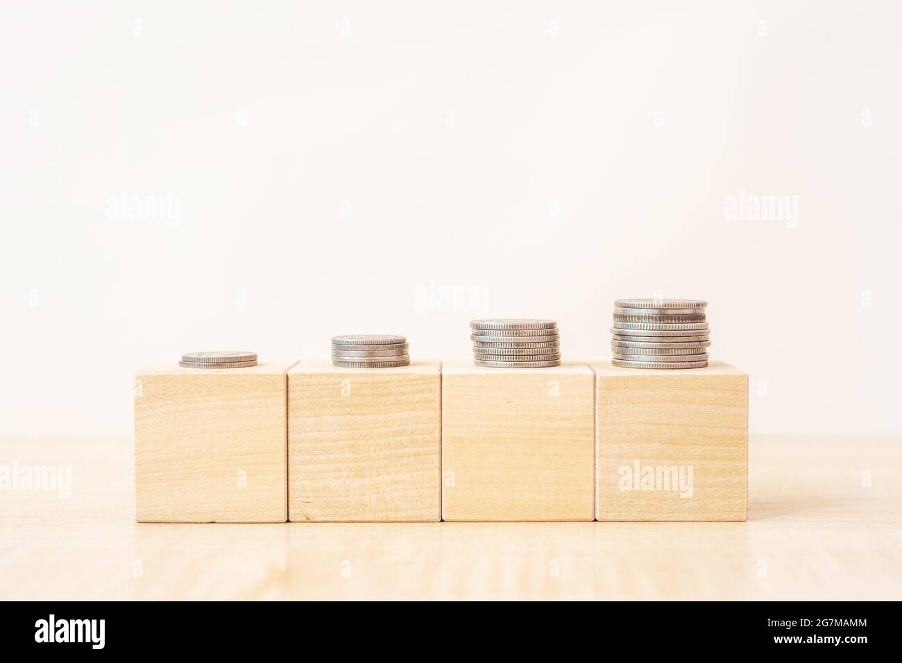 Cubes with stacks of coins on table as money savings concept Stock ...