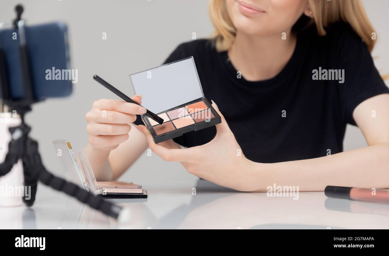 Beauty blogger young woman records video tutorial of course on makeup ...