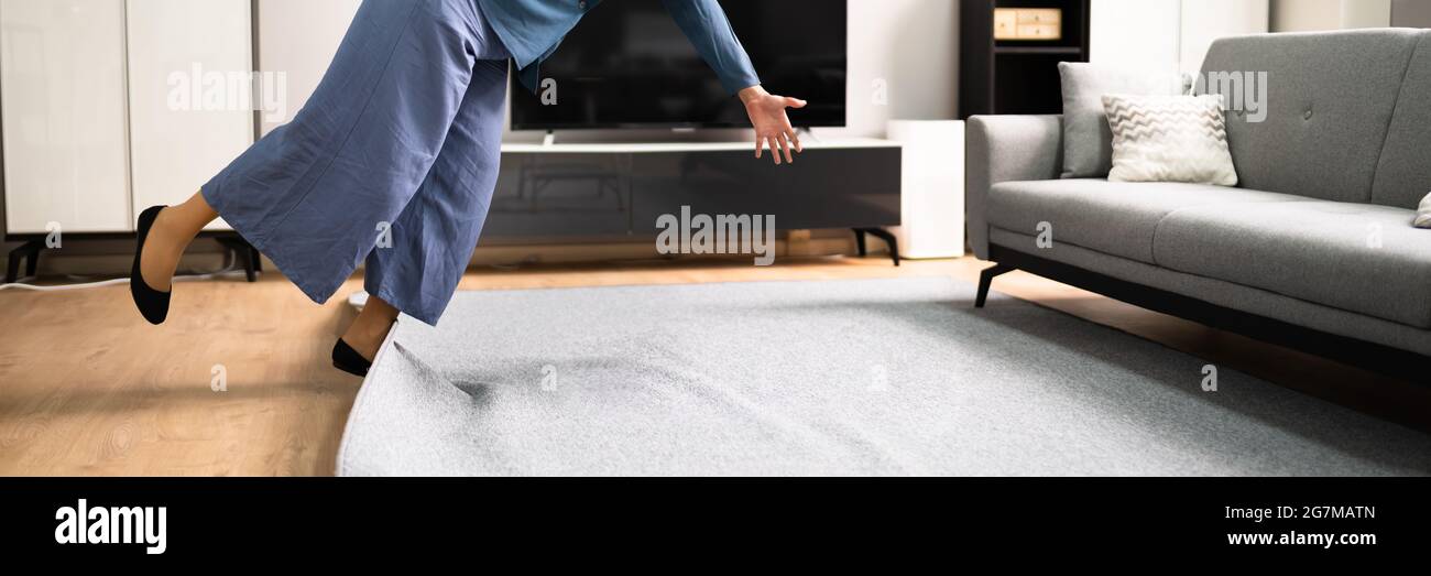 Falldown Hazard. Clumsy Woman Stumbled On Rug Stock Photo - Alamy