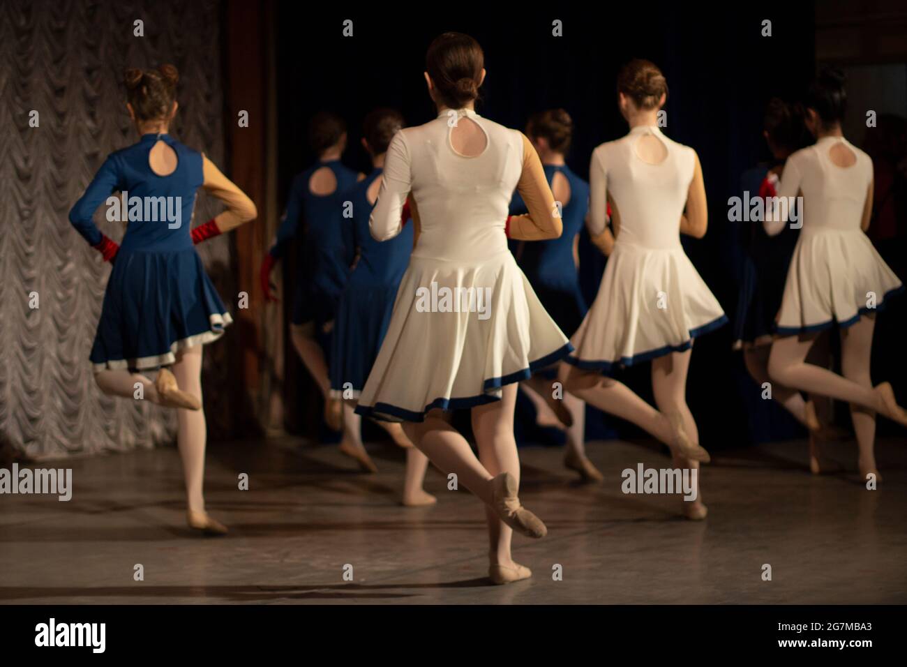 Girls dance on stage. Dance lesson. Beautiful girls in dresses perform ...
