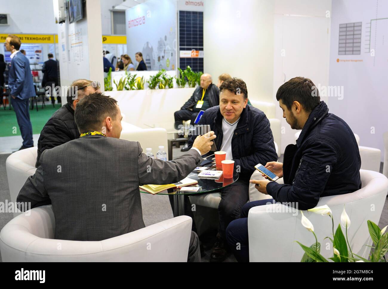 Engaging in dialogue. Businessmen sitting at the tables at the ...