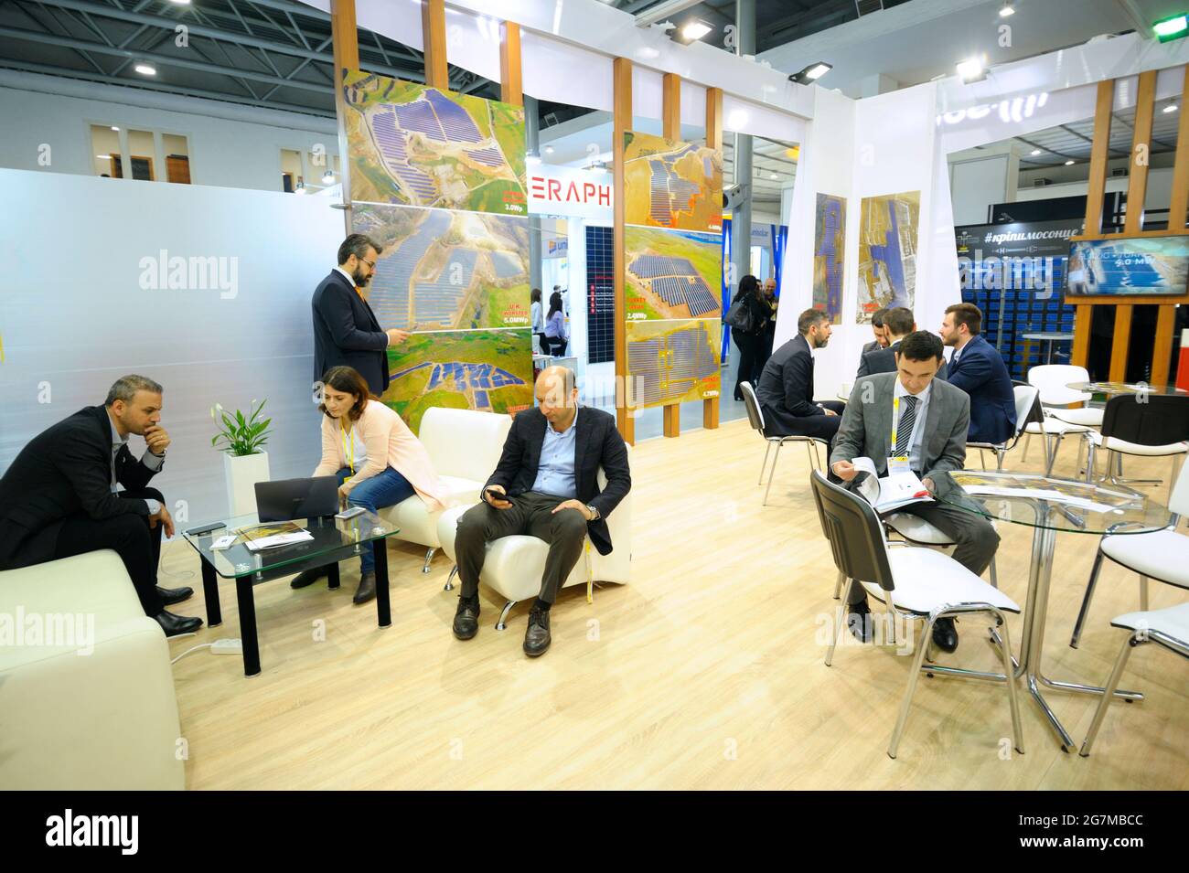 Engaging in dialogue. Businessmen sitting at the tables at the ...