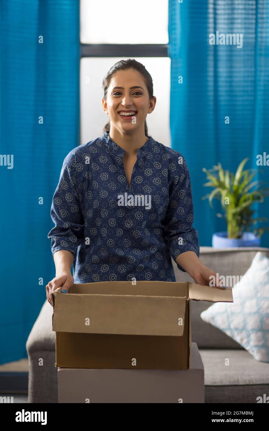 A woman unboxing her new order Stock Photo - Alamy